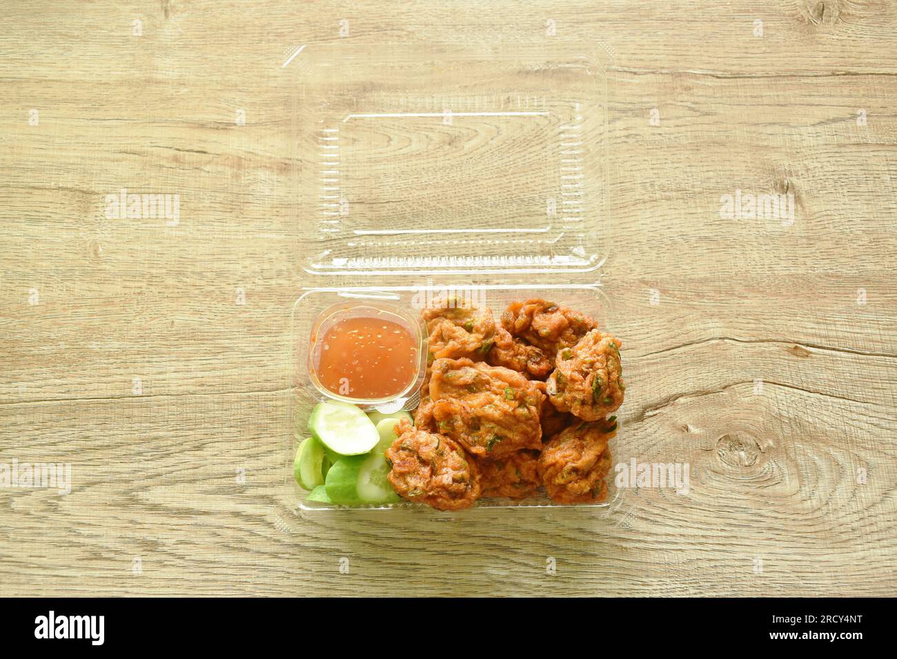 deep fried fish patty with slice cucumber dipping sweet chili sauce in ...