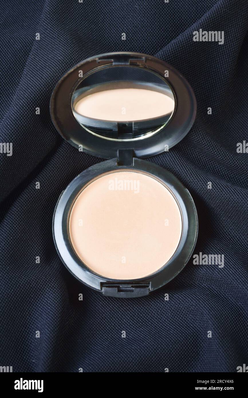powder puff packaging with mirror on black fabric background Stock ...