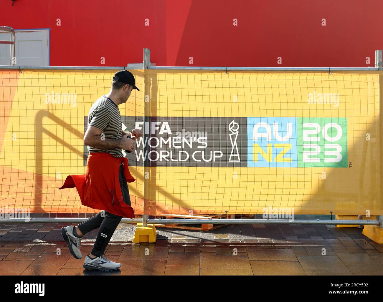Sydney. 17th July, 2023. A man runs past a poster of FIFA Women's World ...