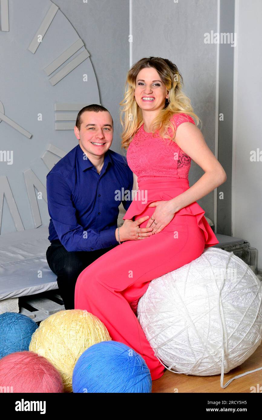 Attractive young couple is celebrating holiday at home. Standing on the ...