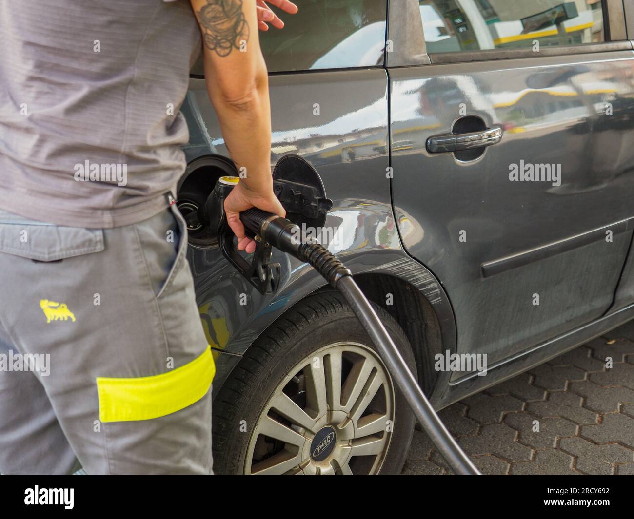 Cremona, Italy - July 3 20223 female attendant servicing a client at ...