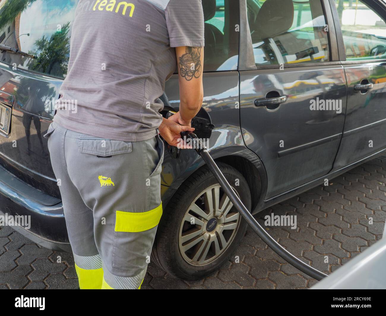 Cremona, Italy - July 3 20223 female attendant servicing a client at ...