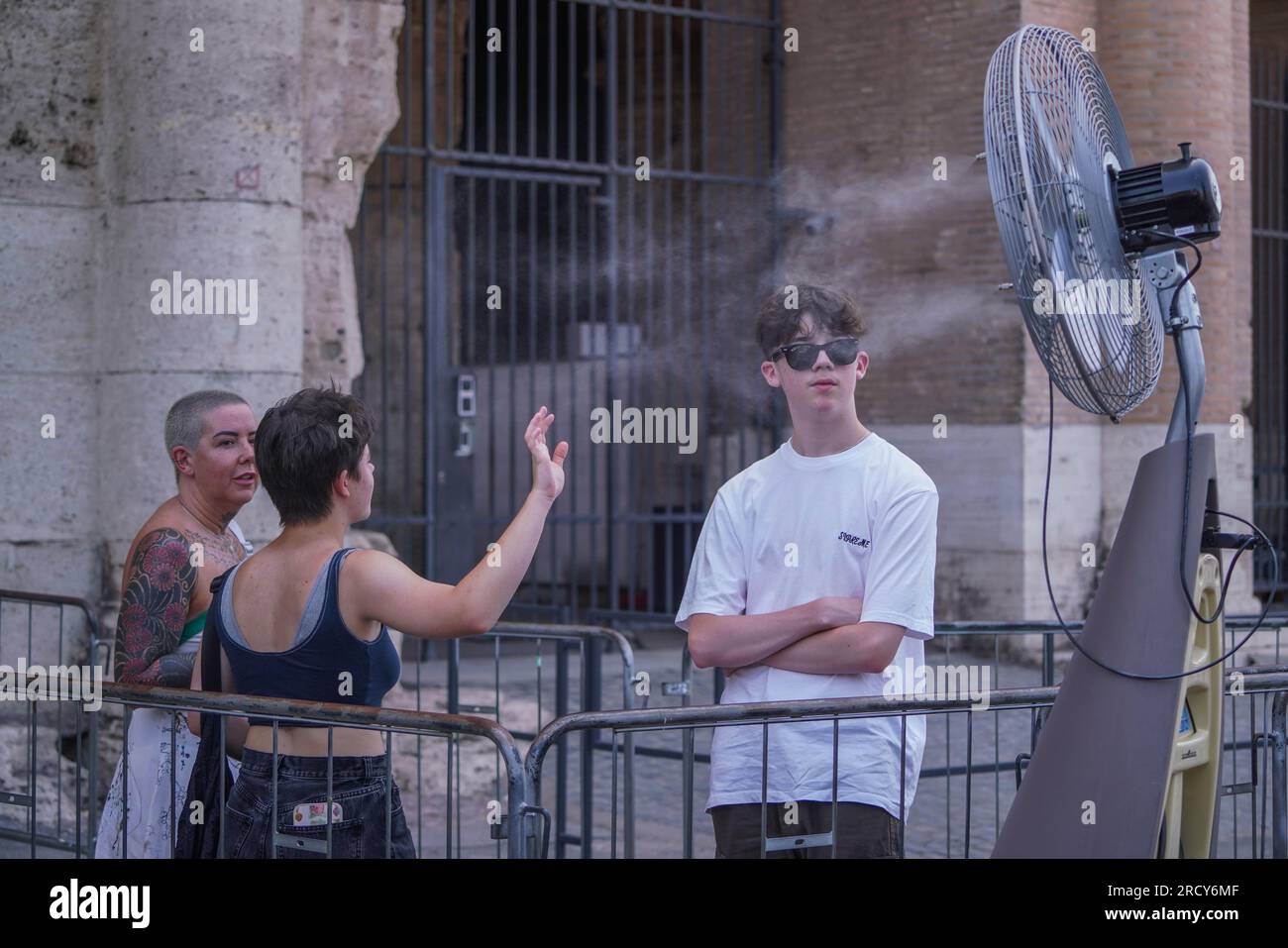 Rome, Italy. 17 July 2023 A tourist at the colosseum fan themselves ...