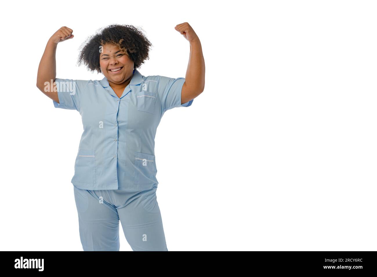 young Afro-Latin medical woman in blue uniform standing empowered with ...