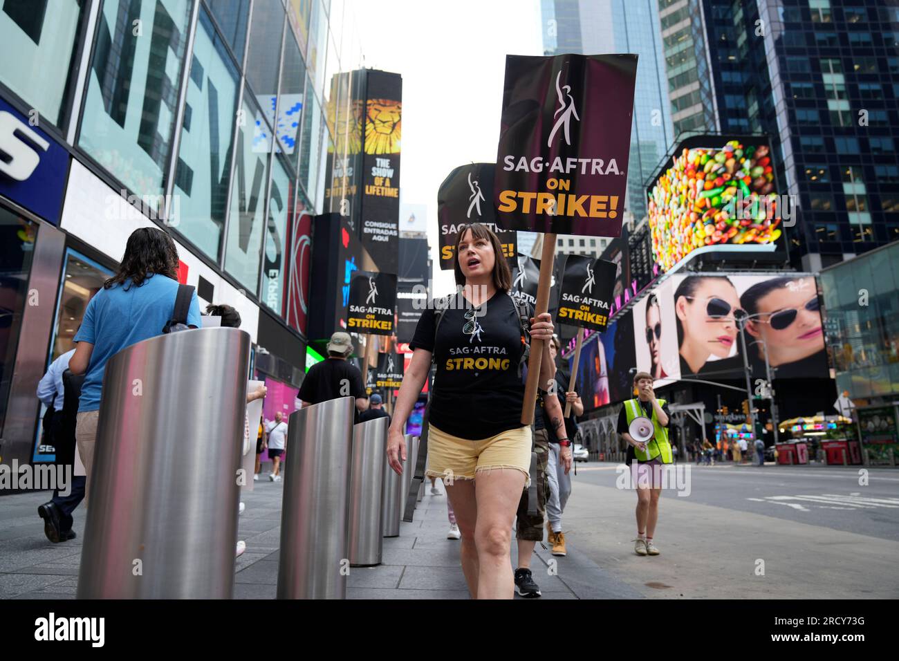 Picketers carry signs outside Paramount in Times Square on Monday, July ...