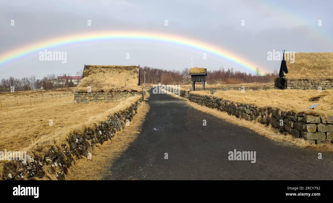 A rainbow shines above old buildings in Arbaer Museum, Reykjavik ...