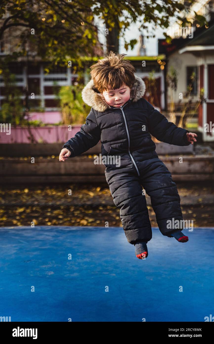 Kid flying, jumping against the gravity. Child 's hair up in the air ...