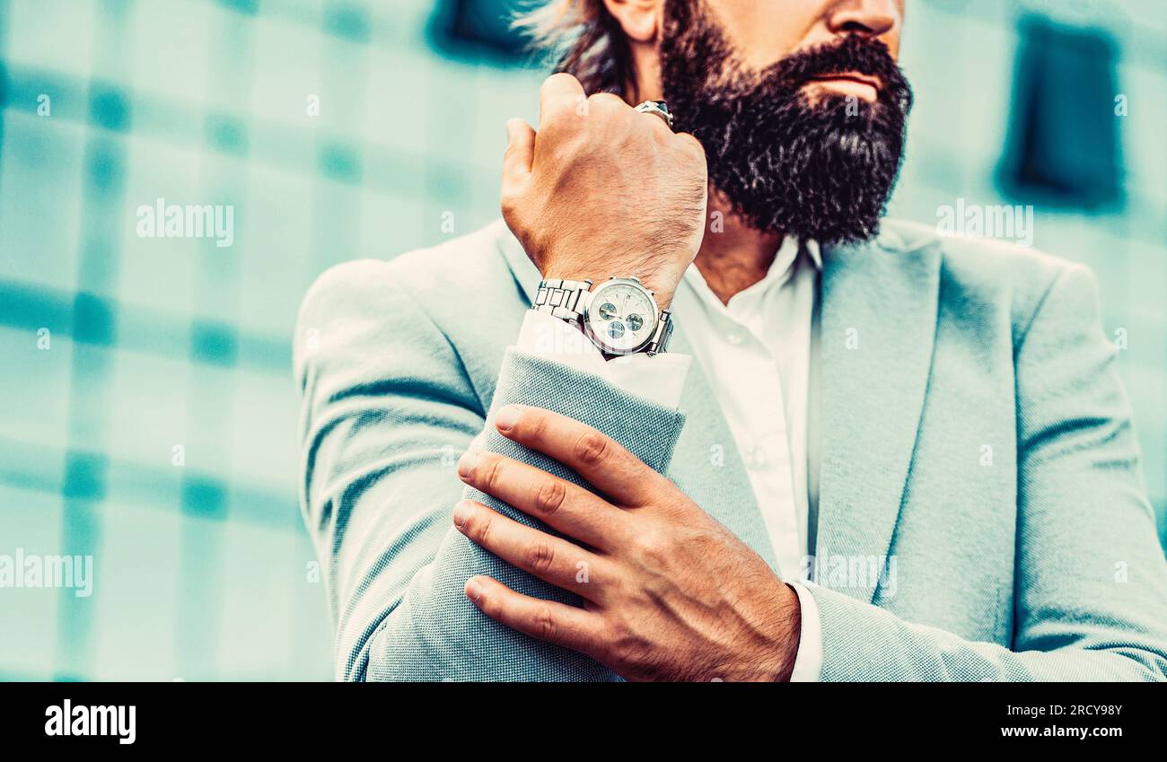 Man holds his watch. Portrait successful businessman in a business suit ...