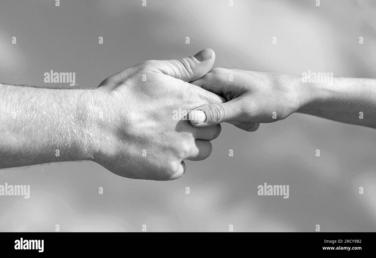 Lending a helping hand. Hands of man and woman reaching to each other ...