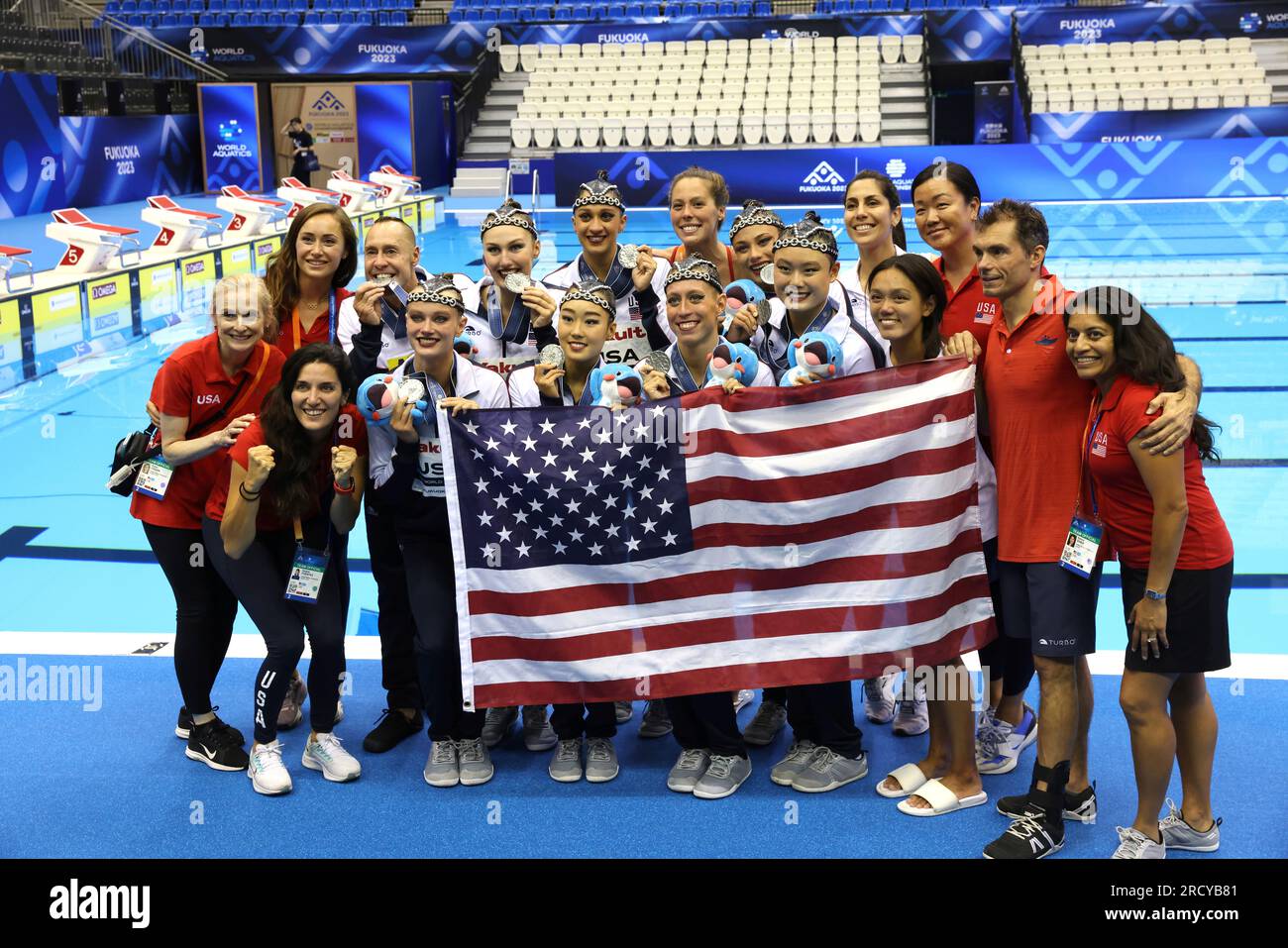 The United States team poses with their silver medals after competing ...