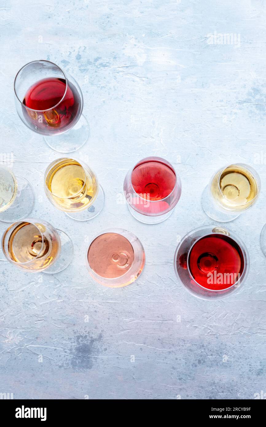 Wine glasses at a tasting. Rose, red, and white wine, drinks on a table ...