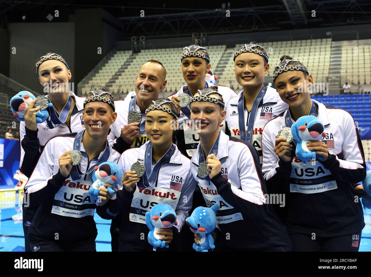 The United States team poses with their silver medals after competing ...