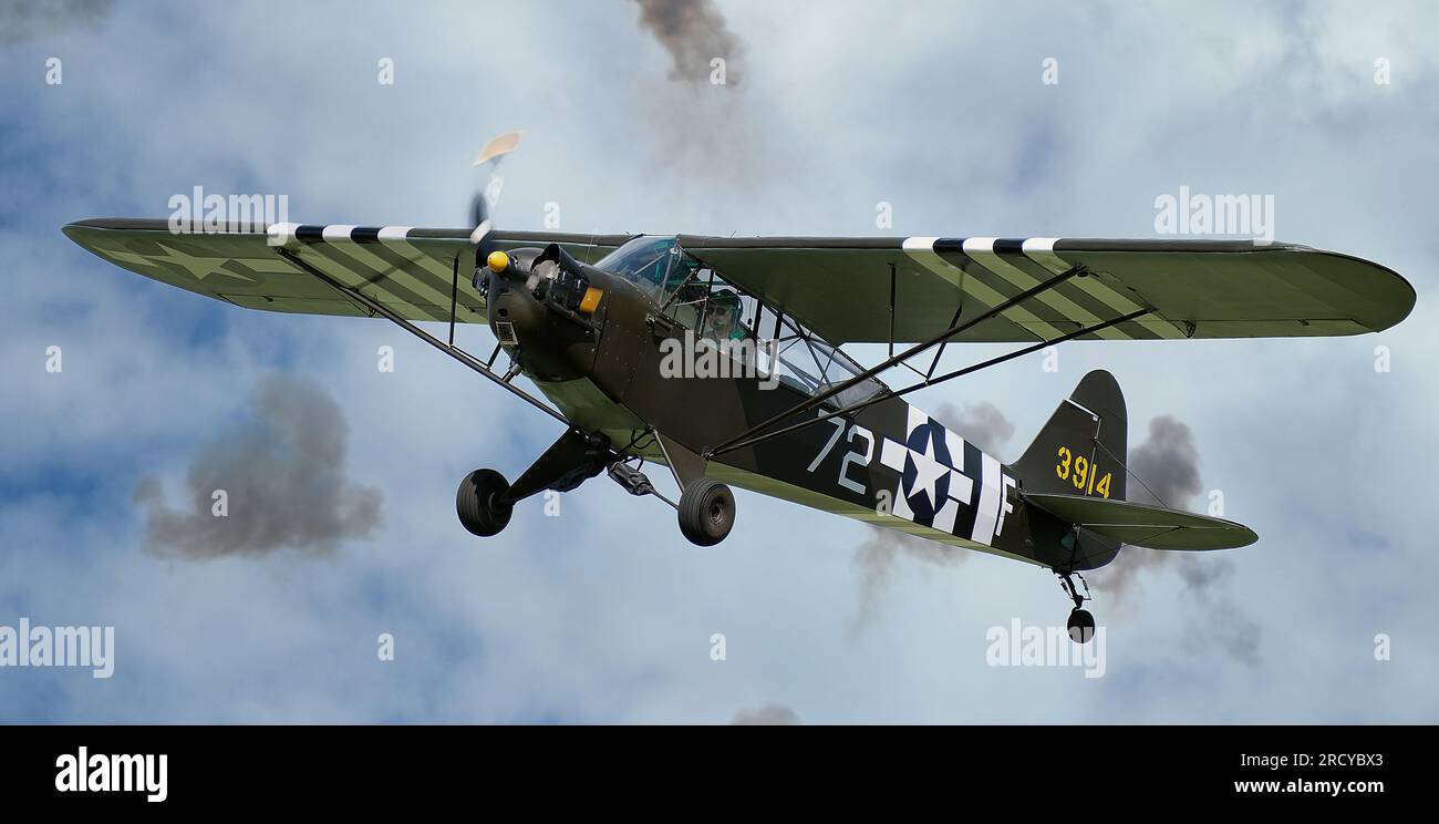 High wing light aircraft flying from provincial grass airfield. The ...