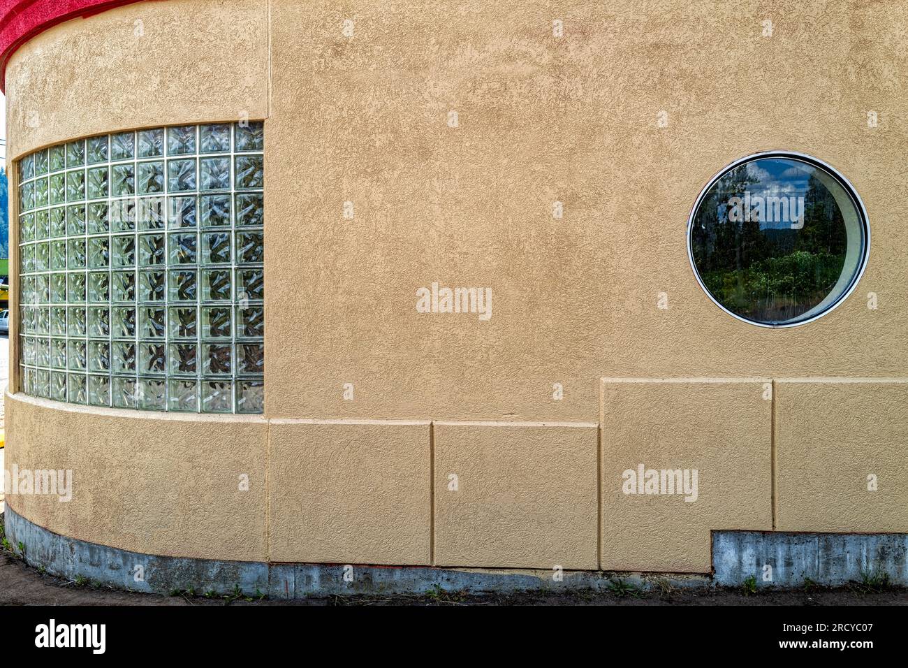 A rounded glass block window and a porthole window on the exterior wall ...