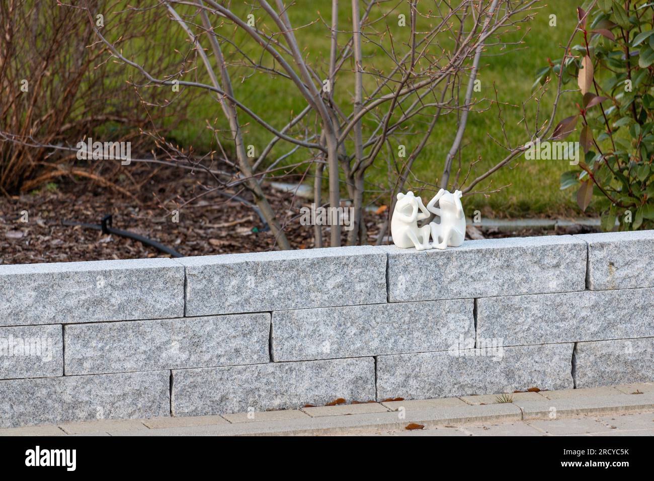 2 small white frog figures sitting on a wall. High quality photo Stock ...