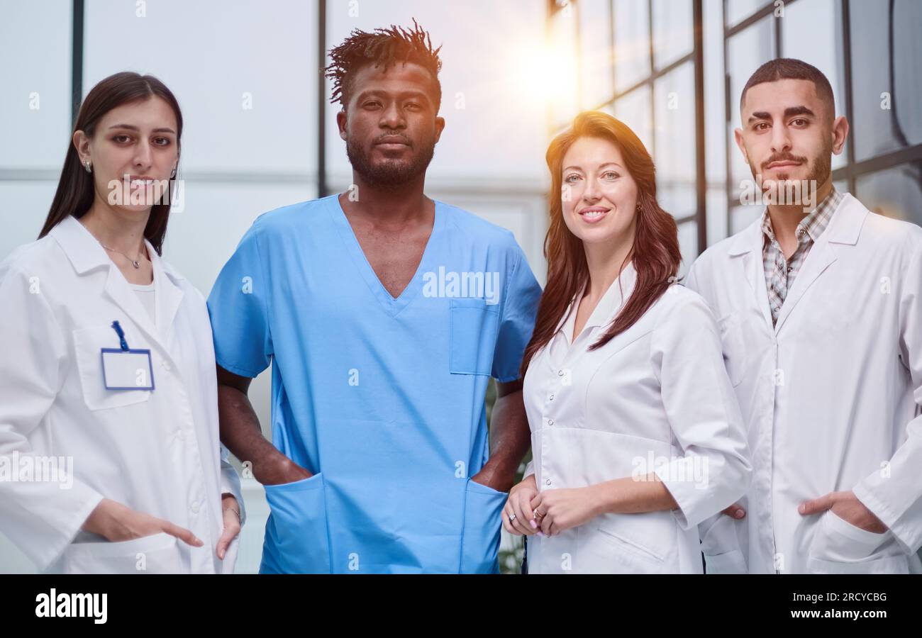 Portrait of a diverse group of male and female doctors smiling in a ...