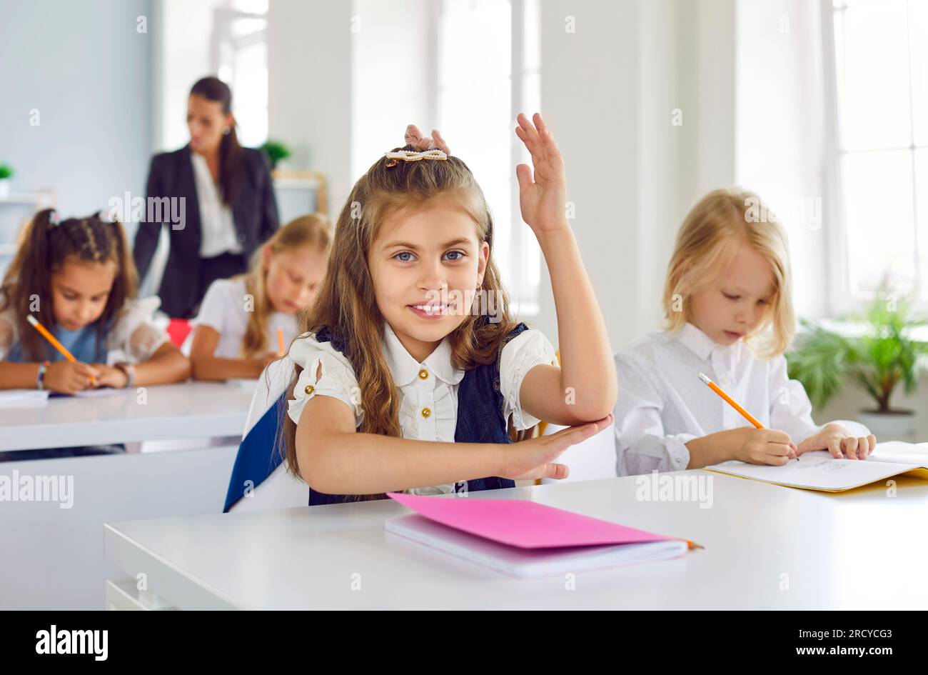 Little smiling girl teen raises hand wants to answer question from ...