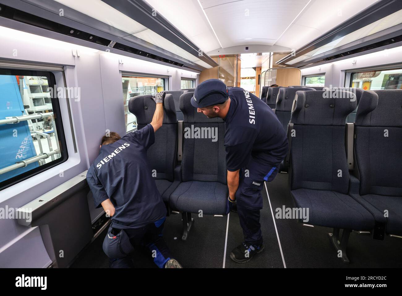 Krefeld, Germany. 17th July, 2023. A Siemens employee assembles seats ...