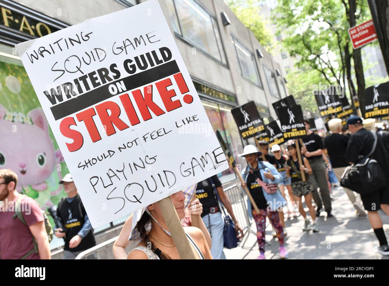 Picketers carry signs outside NBC in Rockefeller Center on Monday, July ...