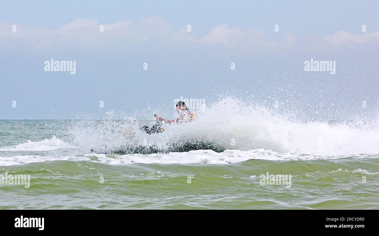 driver of the jet ski turns into the sea with a huge amount of spray ...