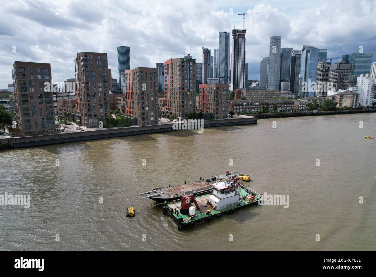 Floating work platform on river thames canary wharf in background ...