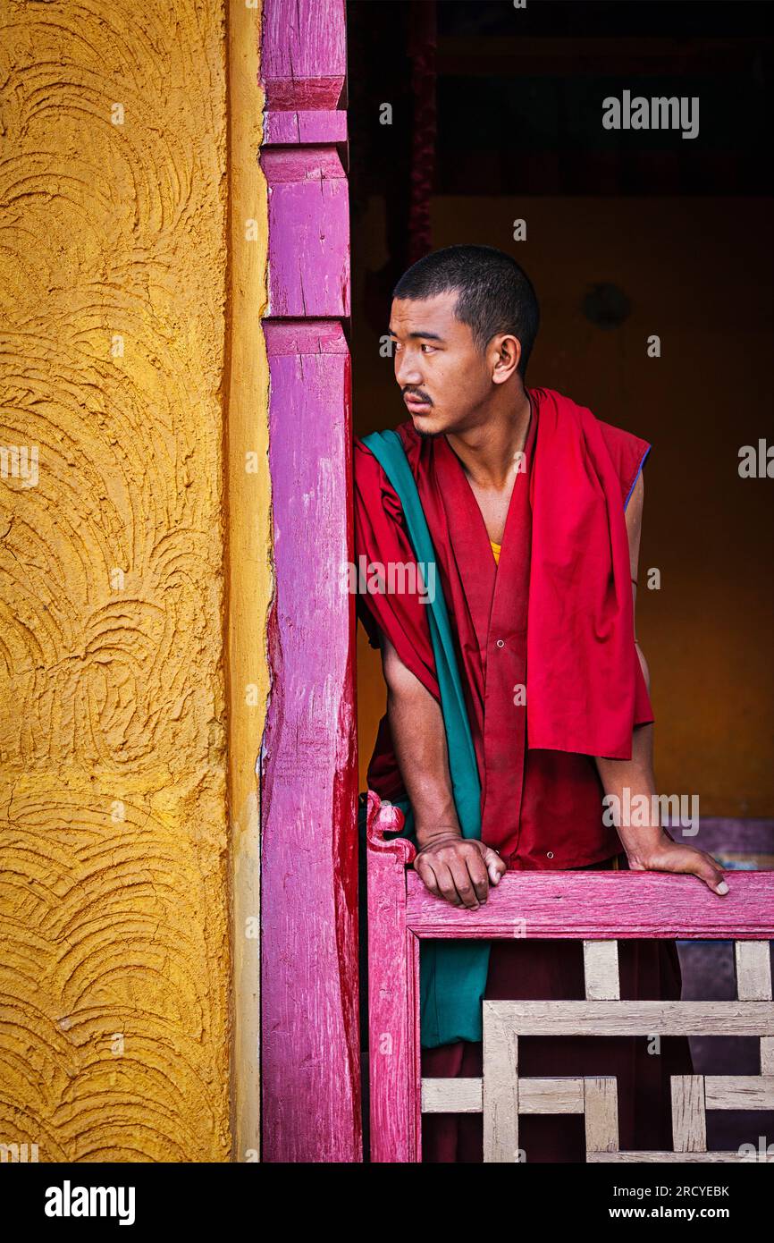 Young Buddhist monk standing in doorway of monastery Stock Photo - Alamy