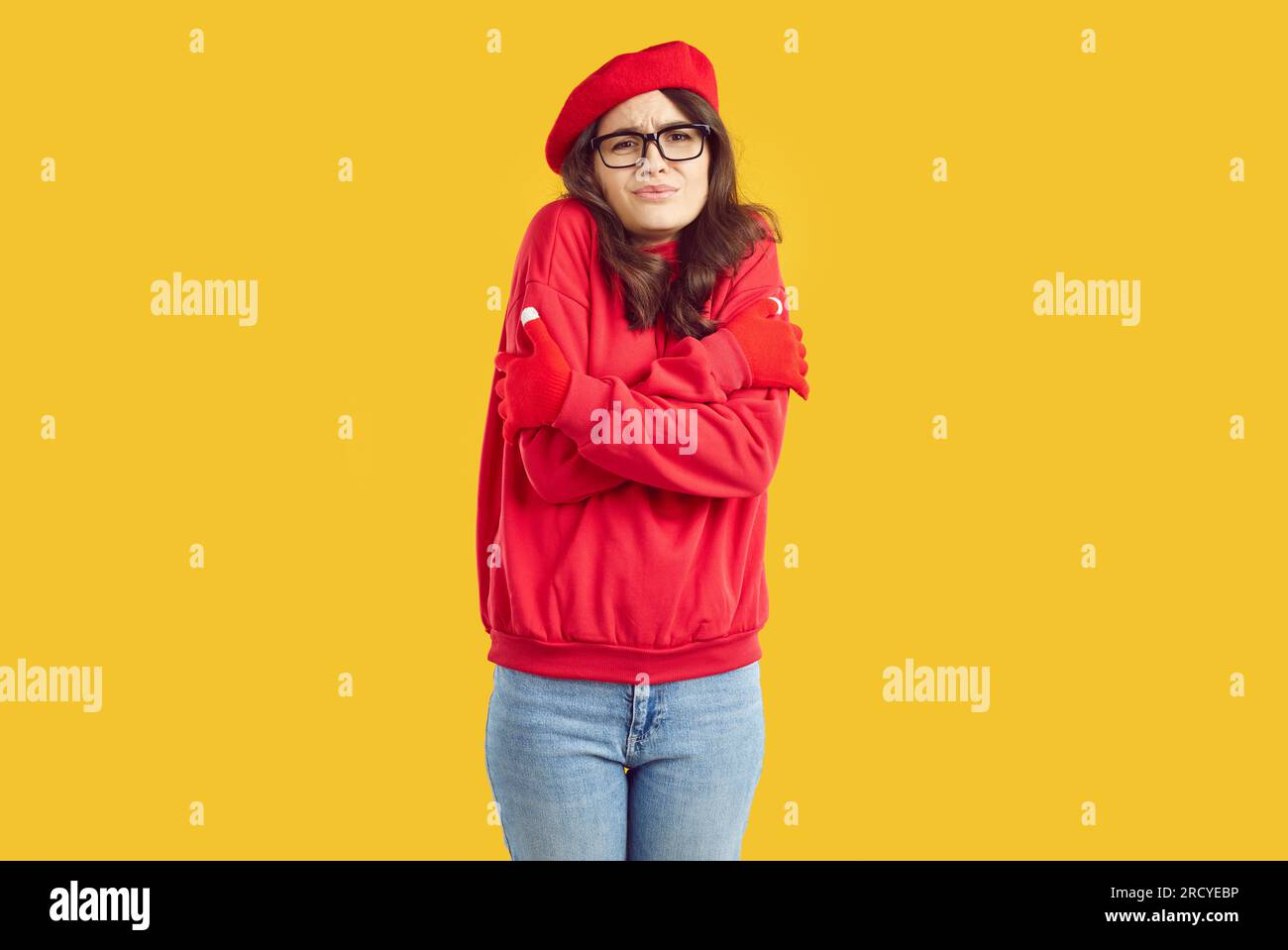 Portrait of dissatisfied young woman who trembling and feeling cold ...