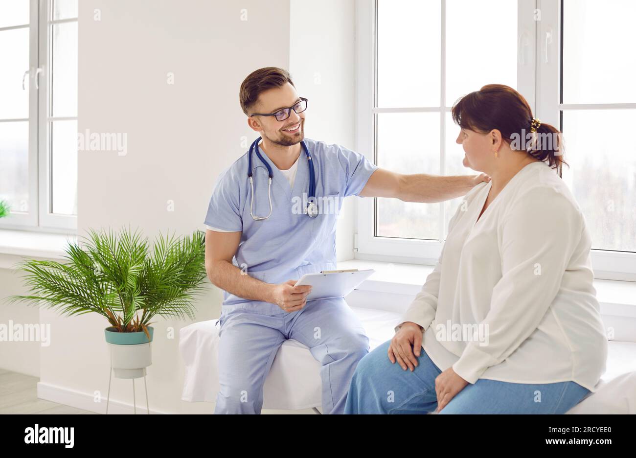 Overweight woman having consultation at doctor's office during medical ...