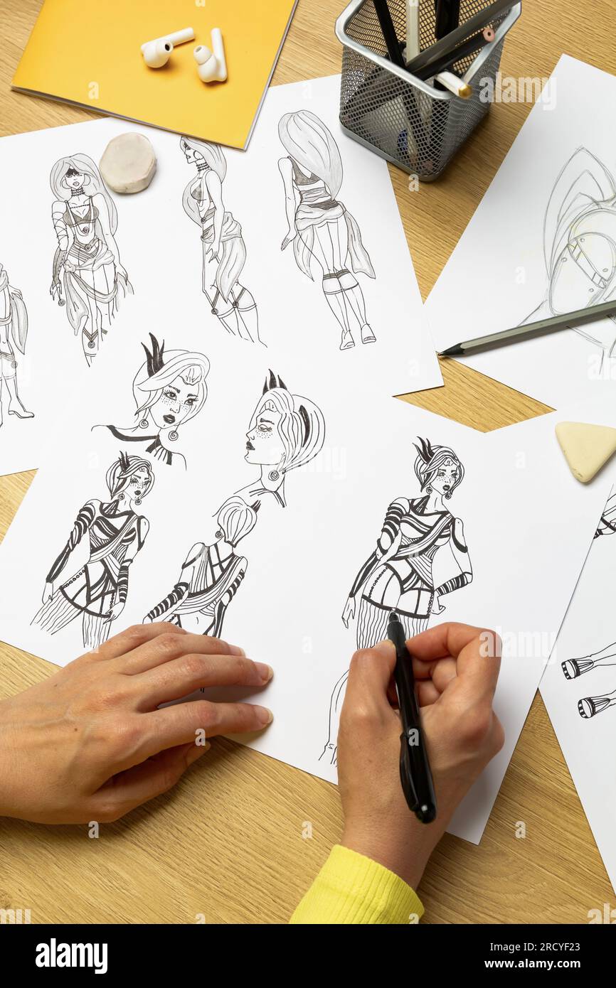 The artist draws on paper characters for computer games or comics Stock ...