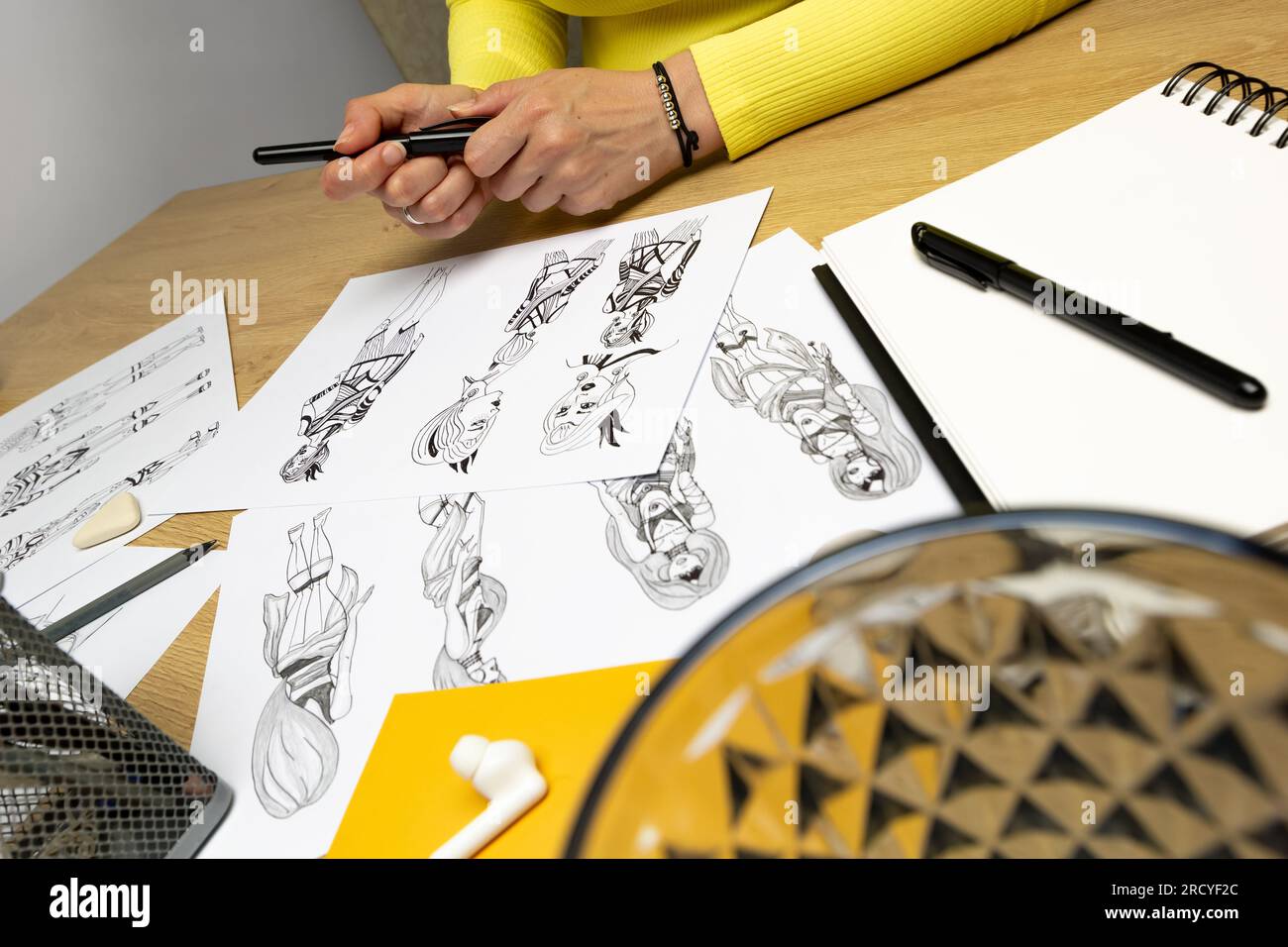 The artist draws on paper characters for computer games or comics Stock ...