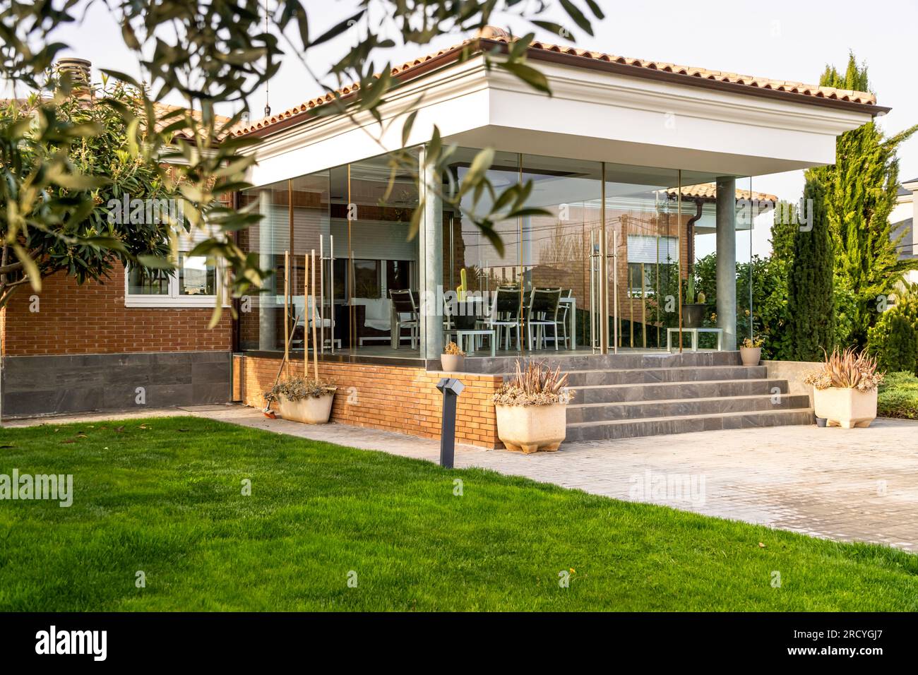 Private family house entry with porch and garden. Side view of the ...