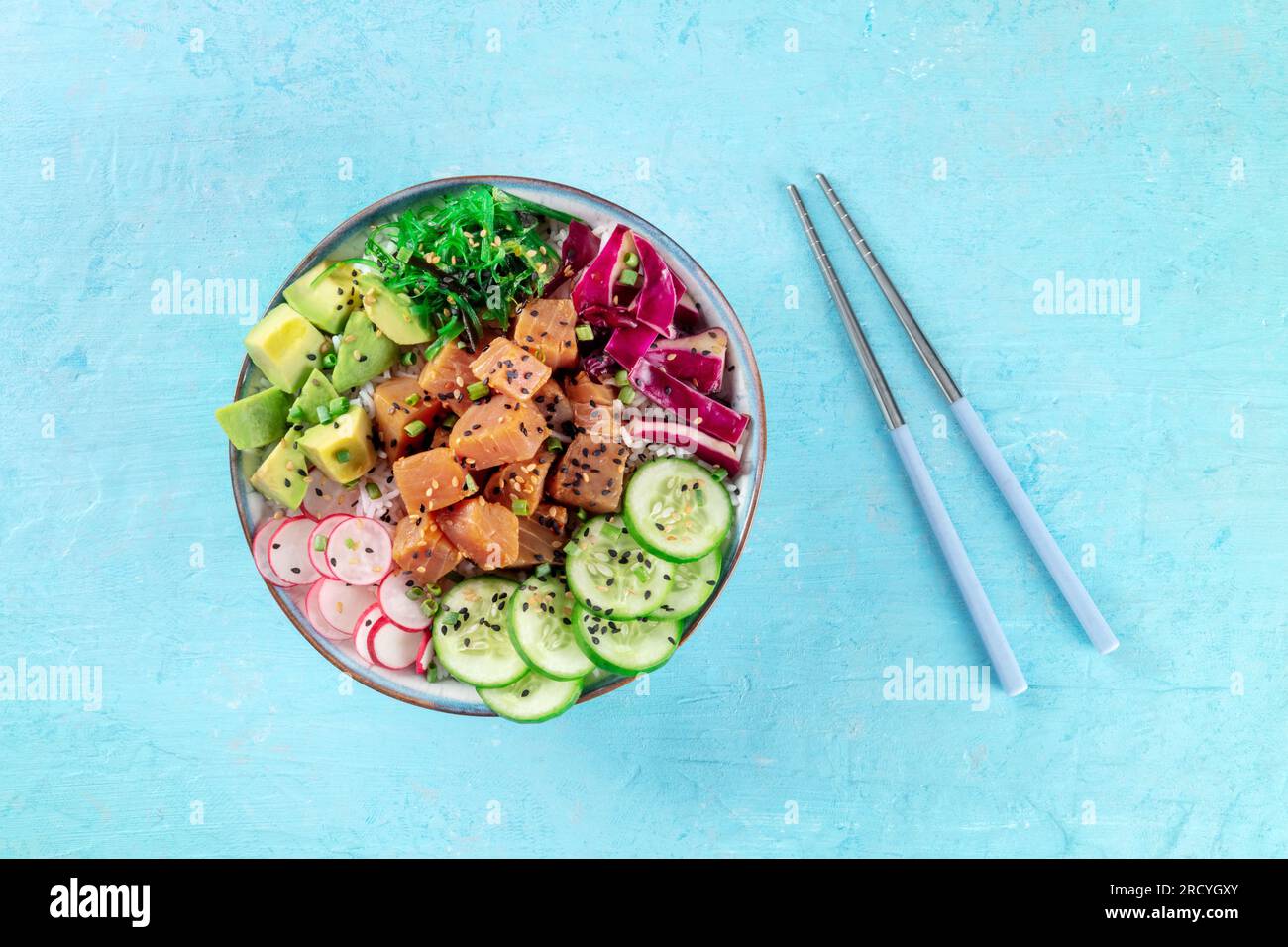 Tuna poke bowl with avocado, cucumbers, wakame, radish, and purple ...