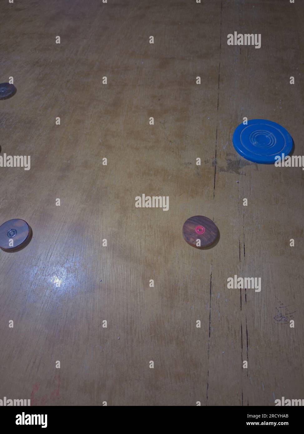 wooden carrom pieces lying on polished board with striker Stock Photo ...