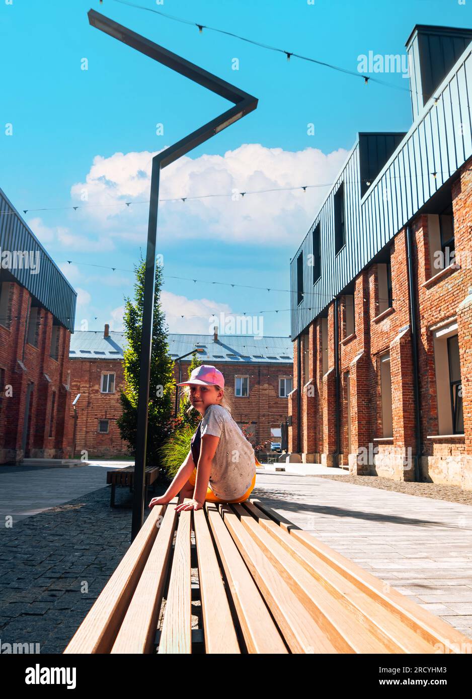 Child girl rests in modern cafe in loft style Break-out area red brick ...