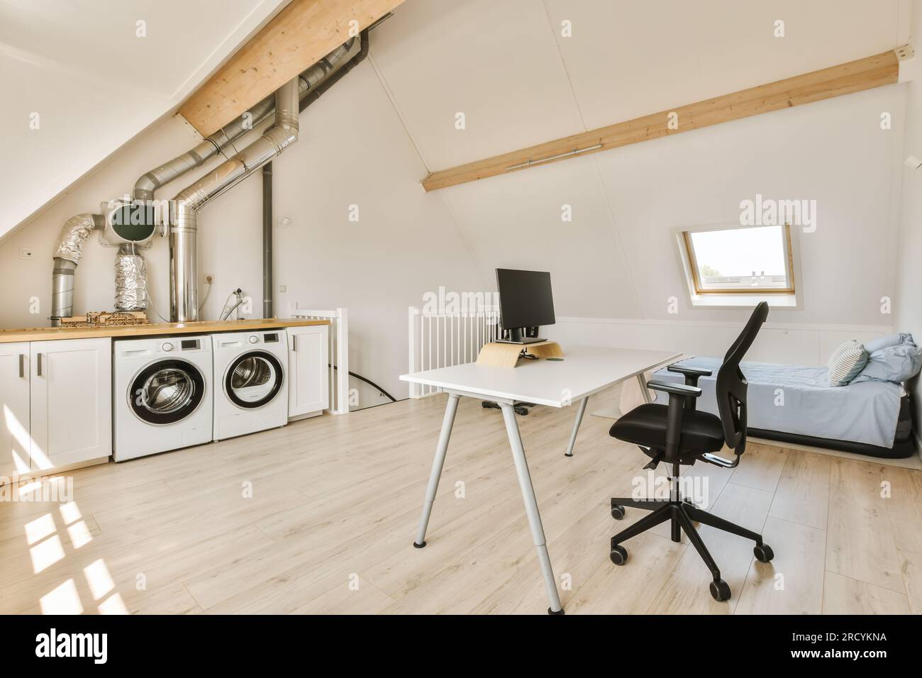 a laundry room with a washer and dryer in the corner, next to an office ...