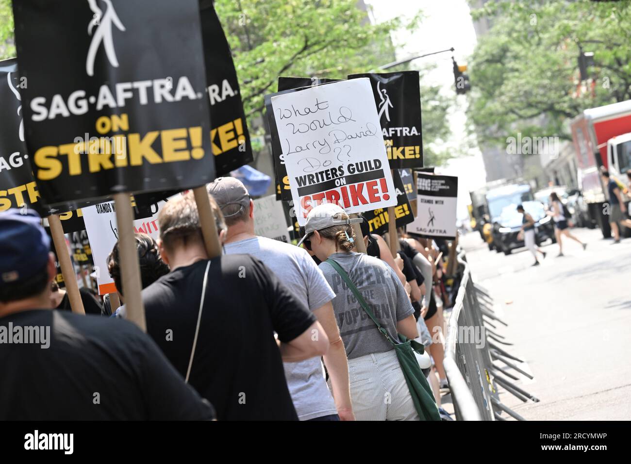 Picketers carry signs outside NBC in Rockefeller Center on Monday, July ...