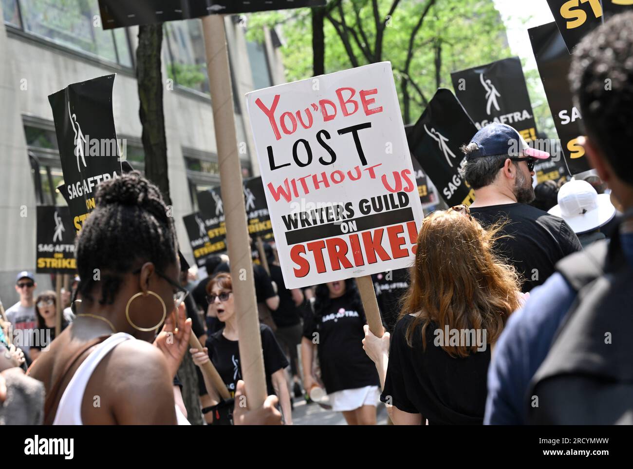 Picketers carry signs outside NBC in Rockefeller Center on Monday, July ...