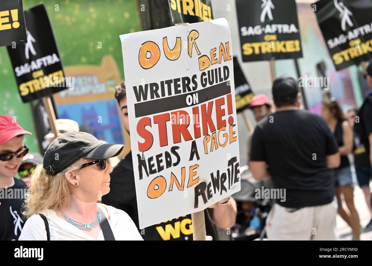 Picketers carry signs outside NBC in Rockefeller Center on Monday, July ...