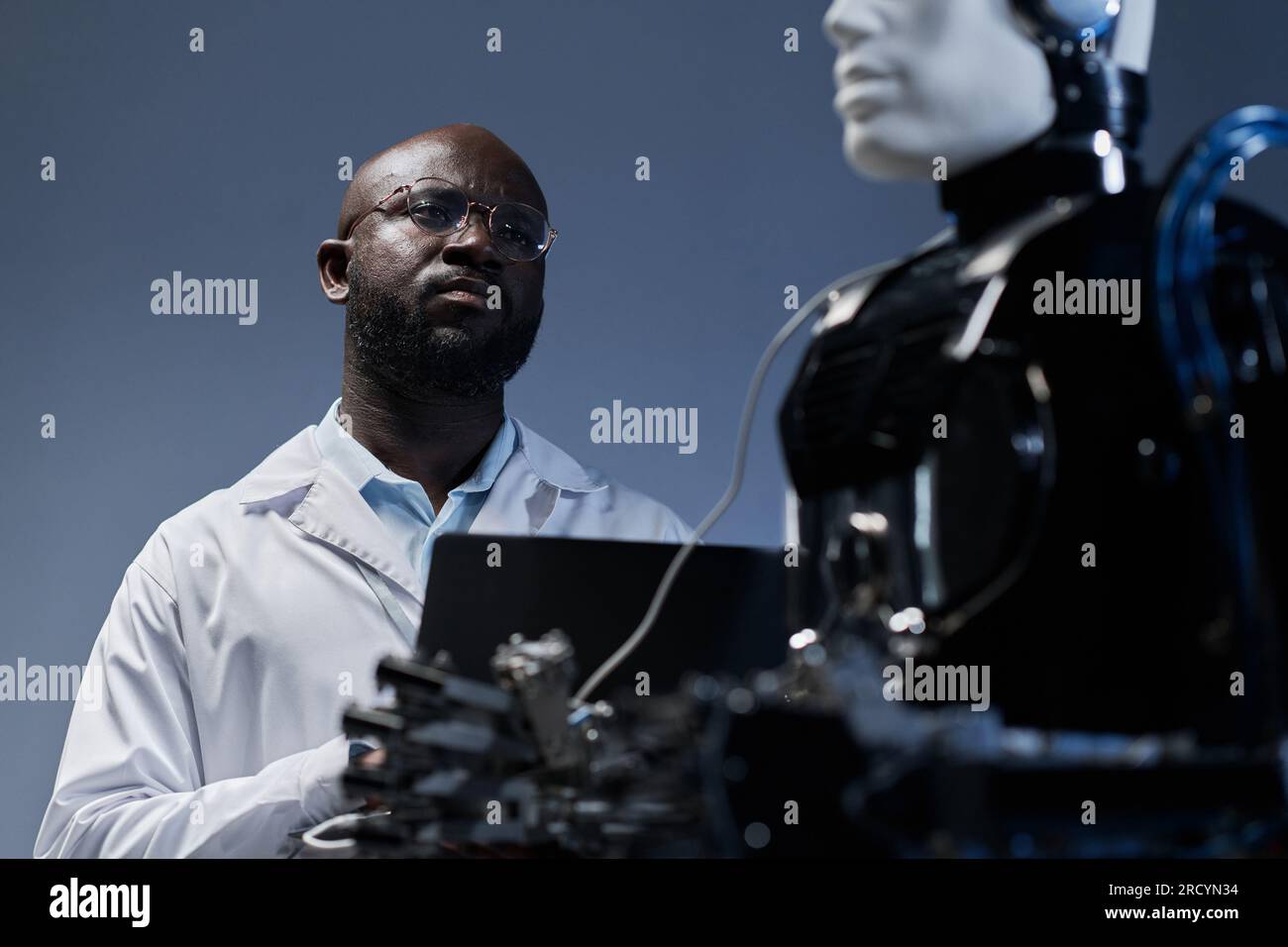African American engineer examining the artificial intelligence of ...
