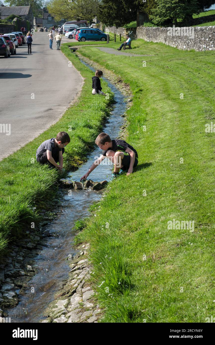 Children playing in the stream at Tissington, Peak District National ...