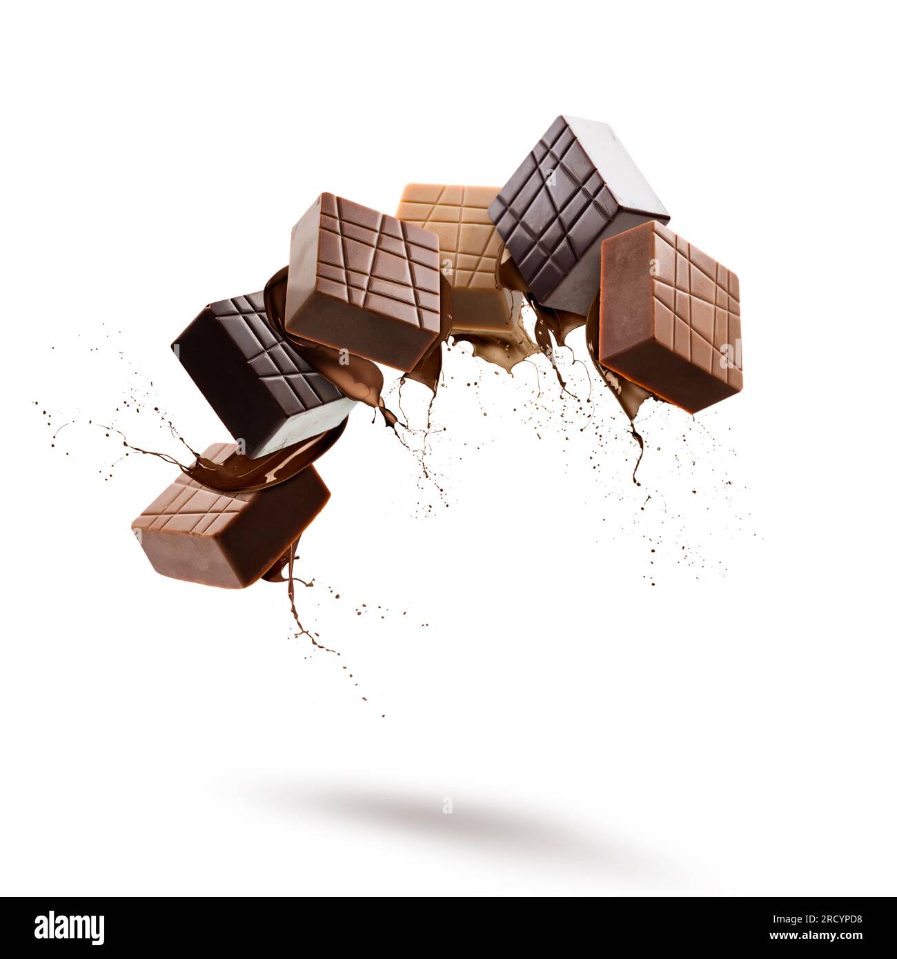 Assorted chocolate pralines floating with melted chocolate splash on ...