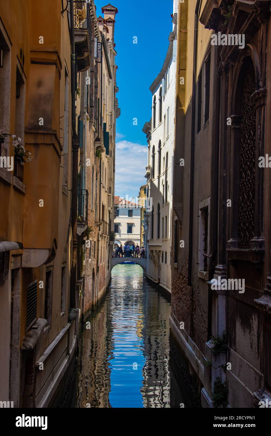 Touristic gondola in narrow grand canal between buildings in Venice ...