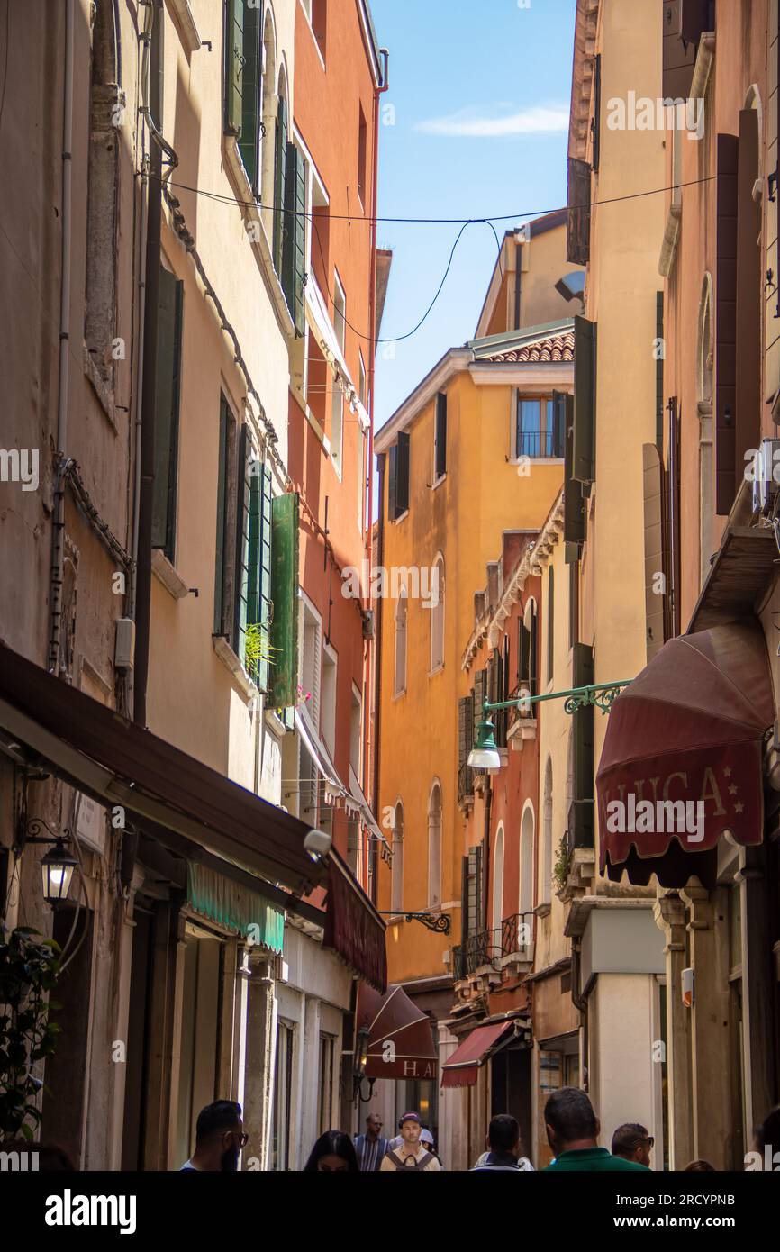 Touristic gondola in narrow grand canal between buildings in Venice ...