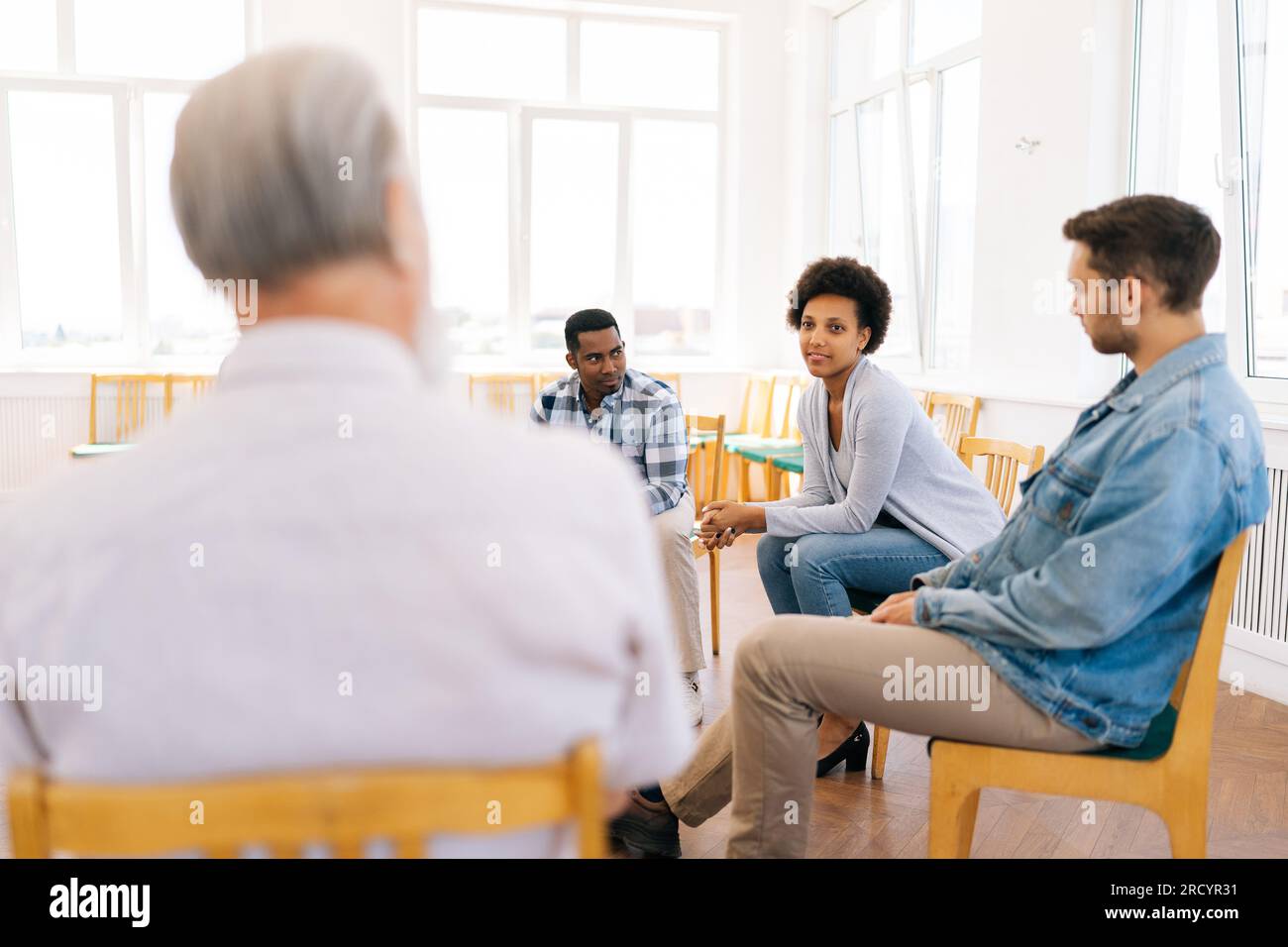 Back view to depressed African American young woman sharing addiction ...