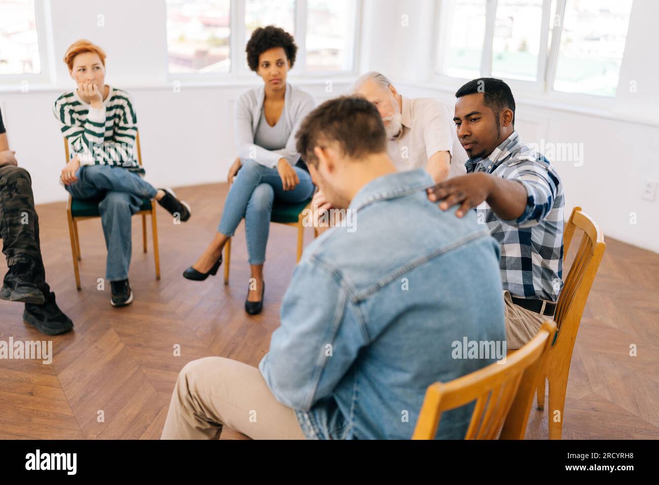 Rear view of unrecognizable sad crying man sharing life problem grief ...