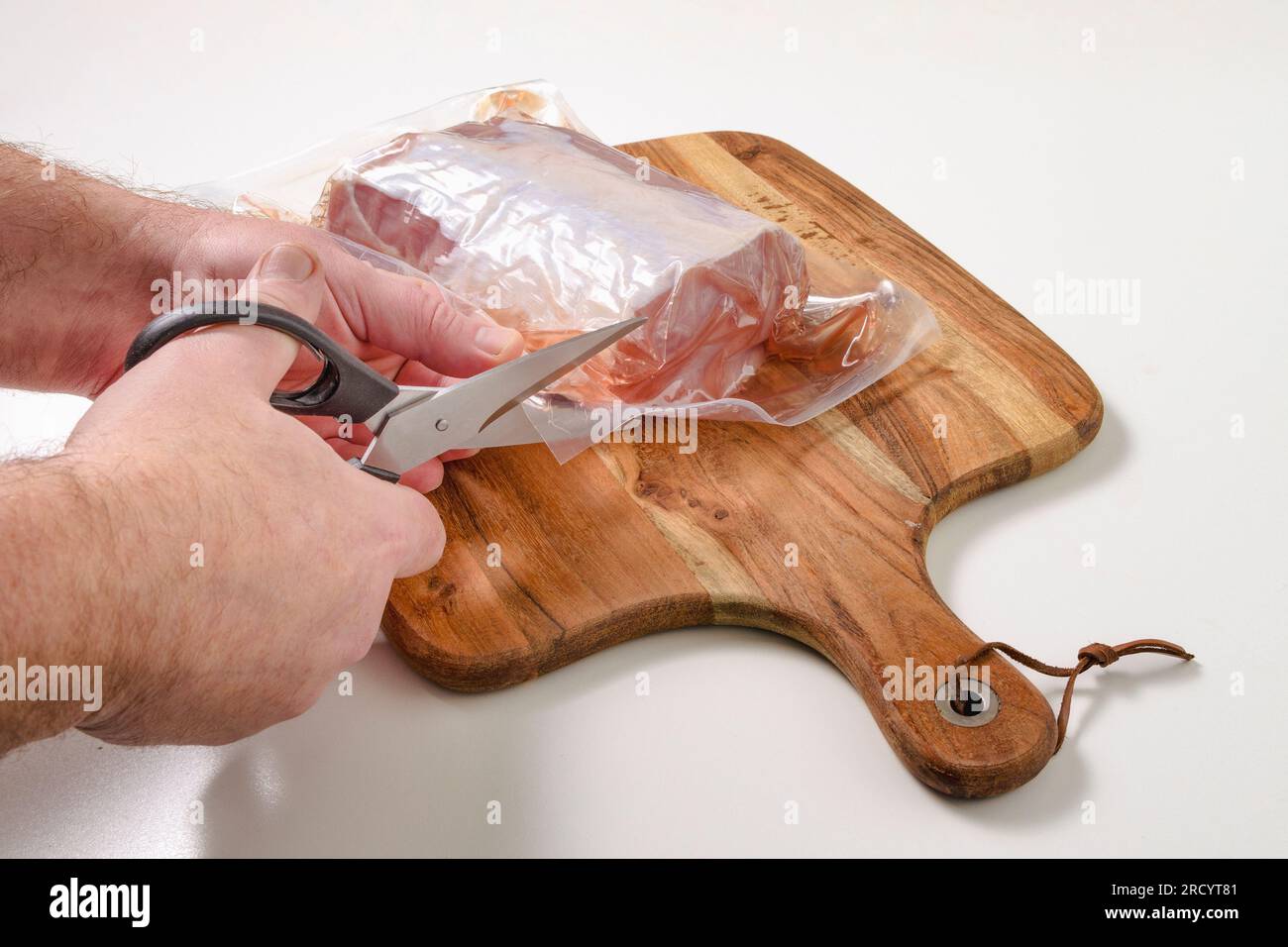 Cut the vacuum packaging along with the product with scissors. Remove ...