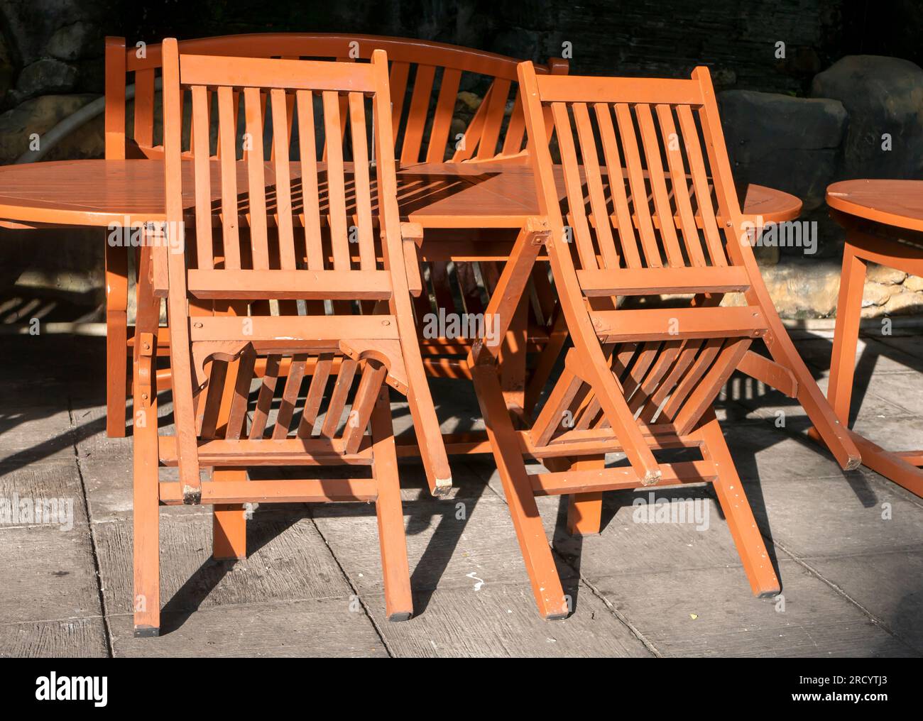 A restaurant closed with wooden chairs leaning against a table Stock ...