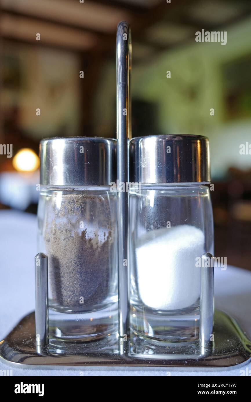 Salt and pepper shakers with holder are on a table Stock Photo - Alamy