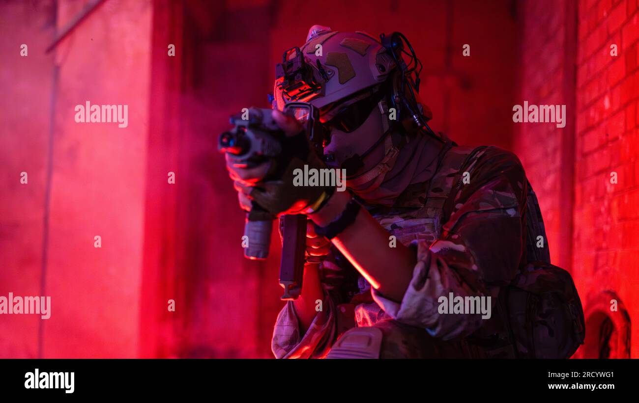Expert team of soldiers with weapons attacking enemy during military ...