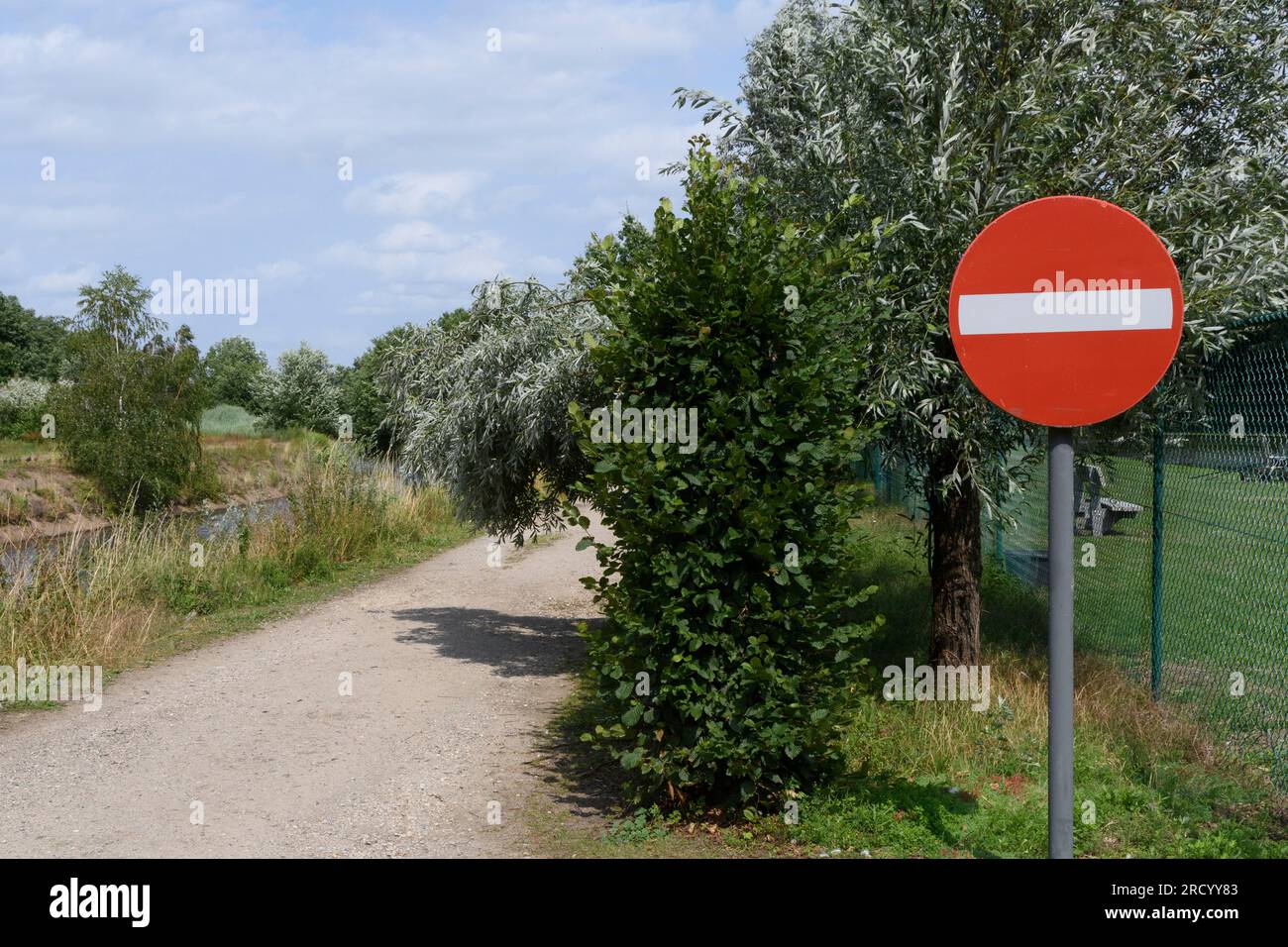 Sign prohibiting the entry of cars into the park area. Path along the ...